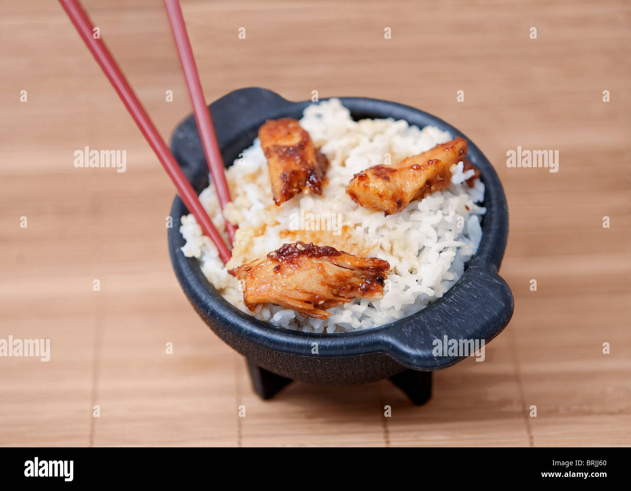one bowl of homemade healthy sesame chicken over white rice with ...