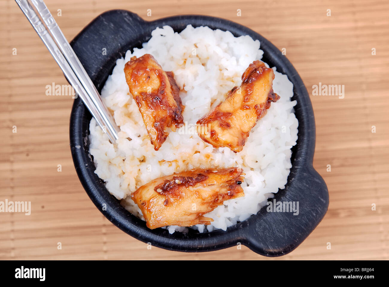 one bowl of homemade healthy sesame chicken over white rice with ...