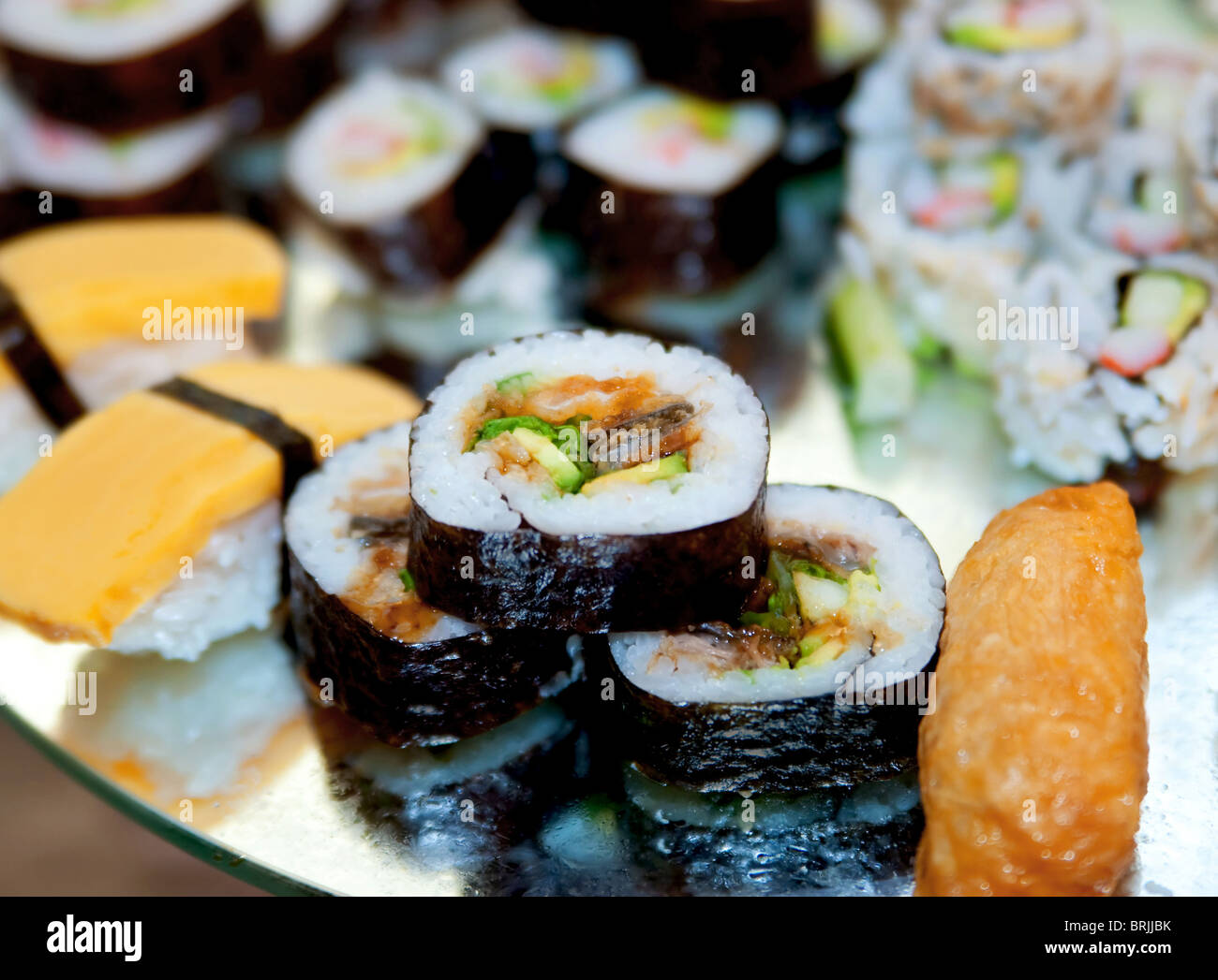 plate of rice sushi rolls stacked on a metal tray Stock Photo - Alamy