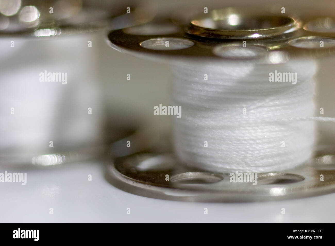 Bobbins of White Thread Stock Photo - Alamy