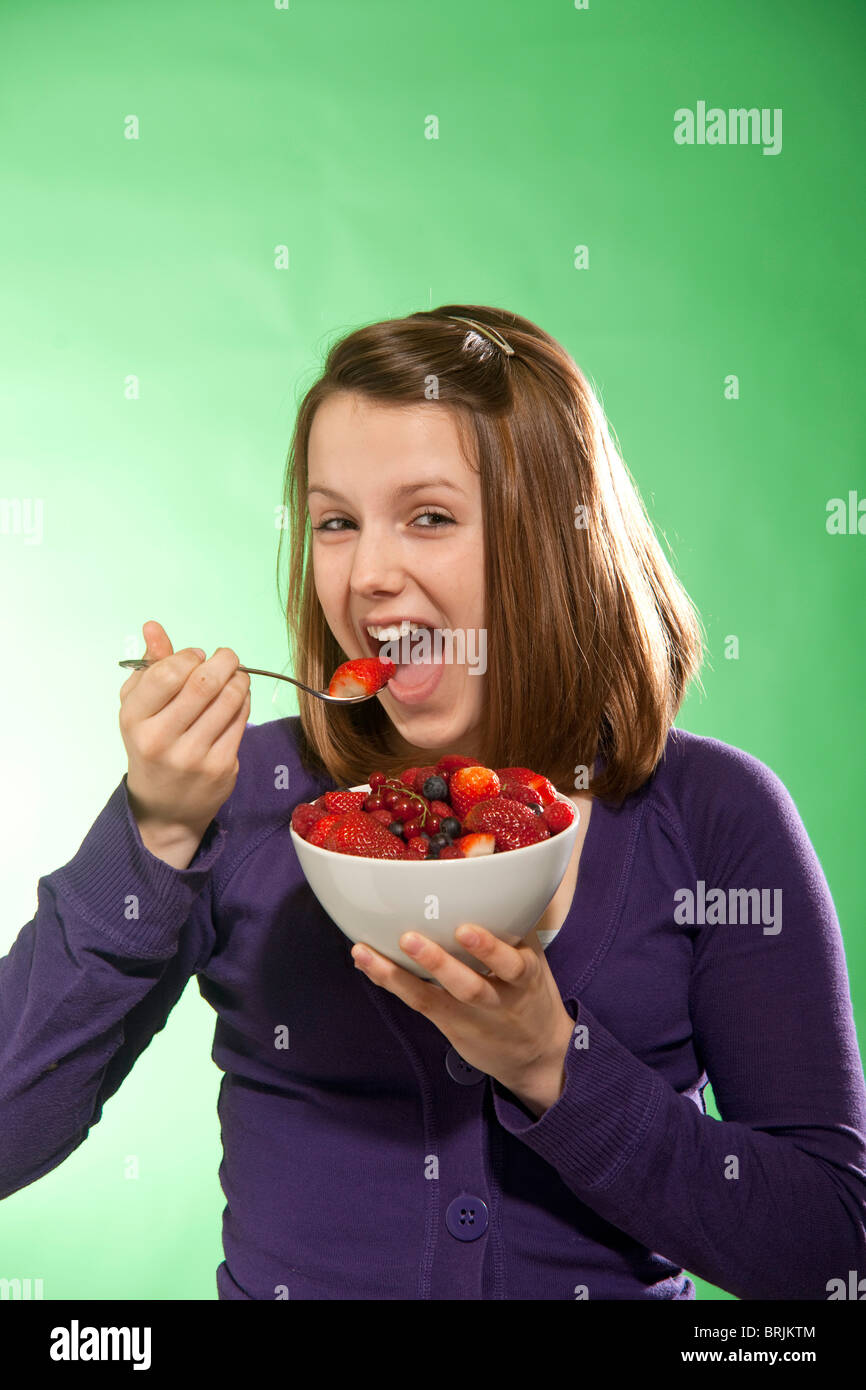 Teenage Girl Eating Bowl of Berries Stock Photo - Alamy