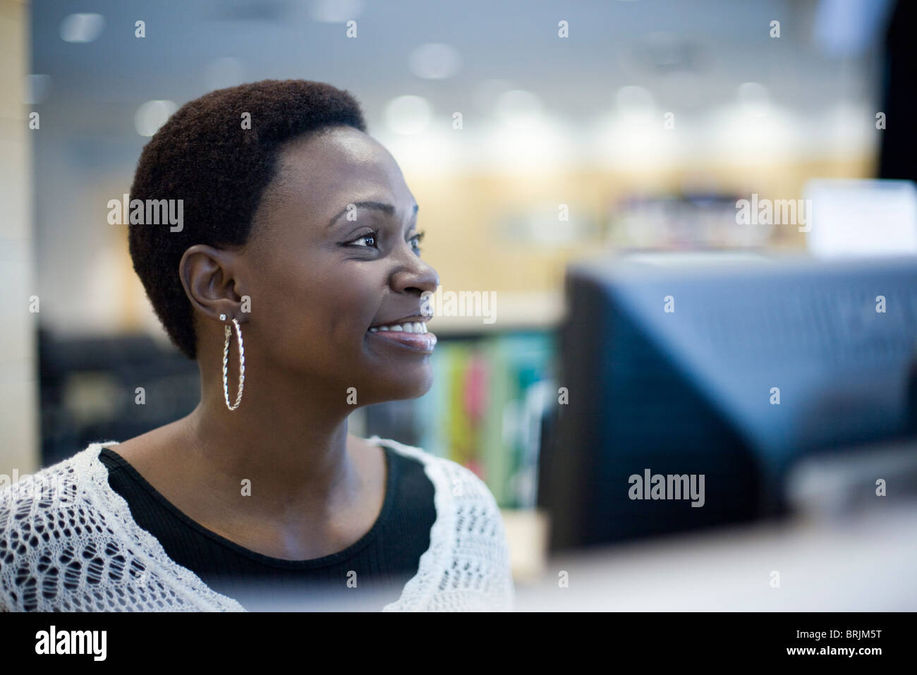 Female office worker looking away smiling Stock Photo - Alamy