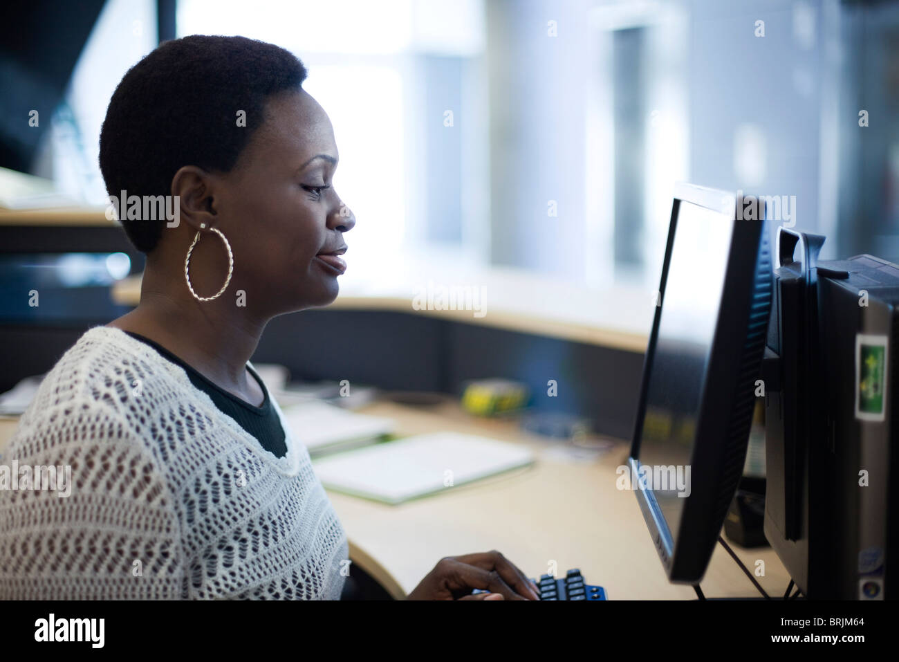 Female receptionist typing Stock Photo - Alamy
