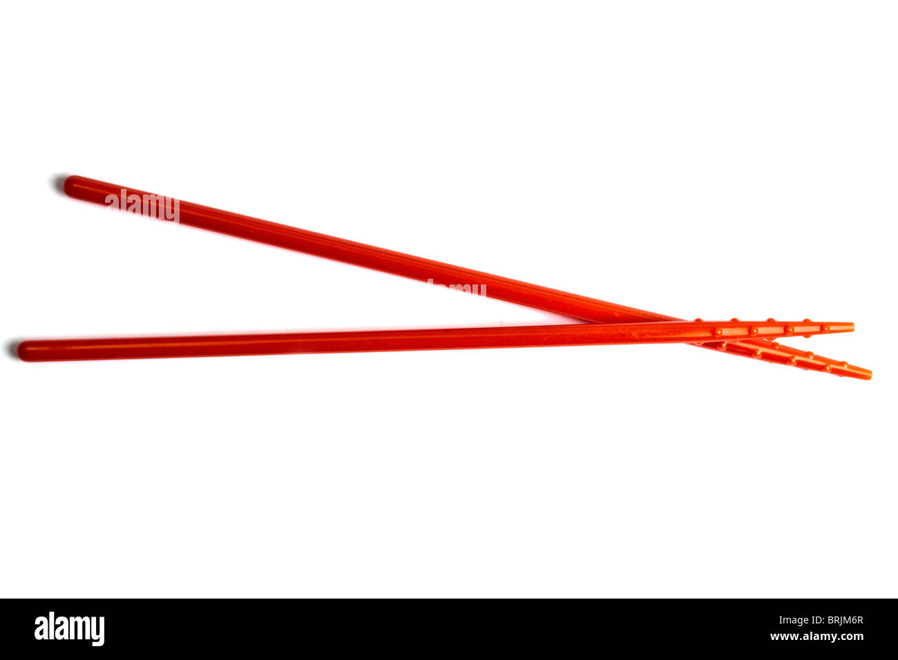 Red chopsticks isolated on white background Stock Photo - Alamy
