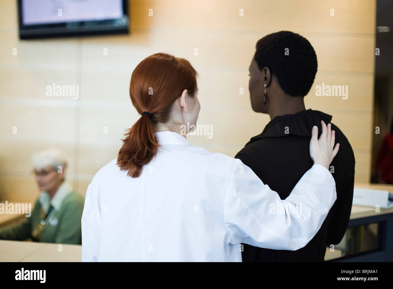 Female healthcare worker reassuring patient Stock Photo - Alamy
