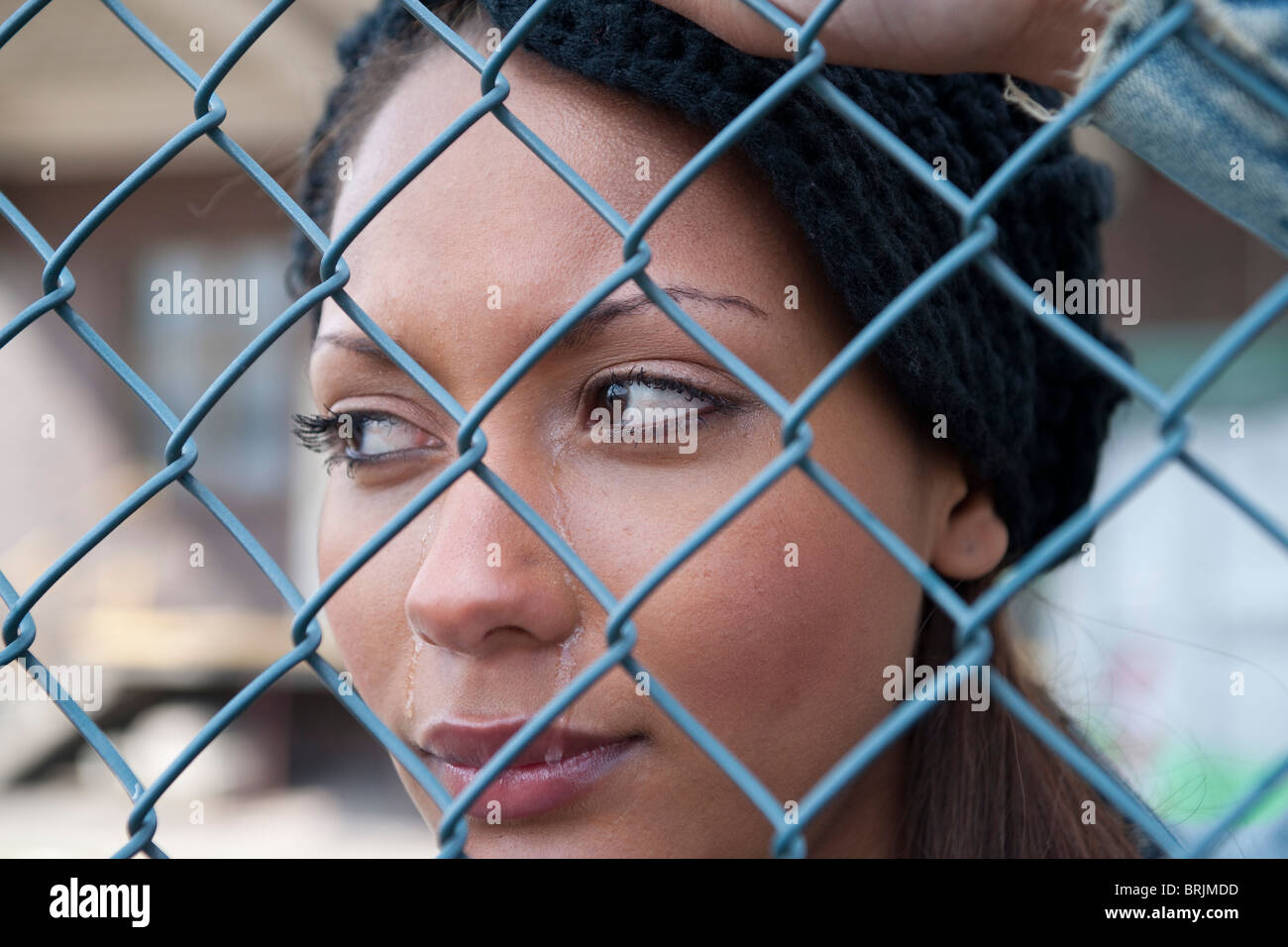 Woman Crying behind Fence Stock Photo - Alamy
