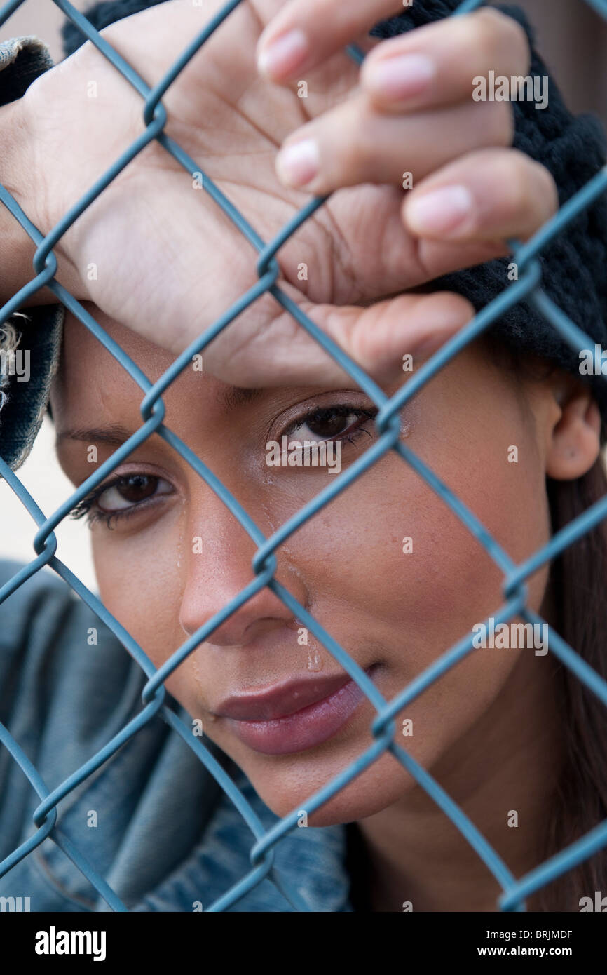 Woman Crying behind Fence Stock Photo - Alamy