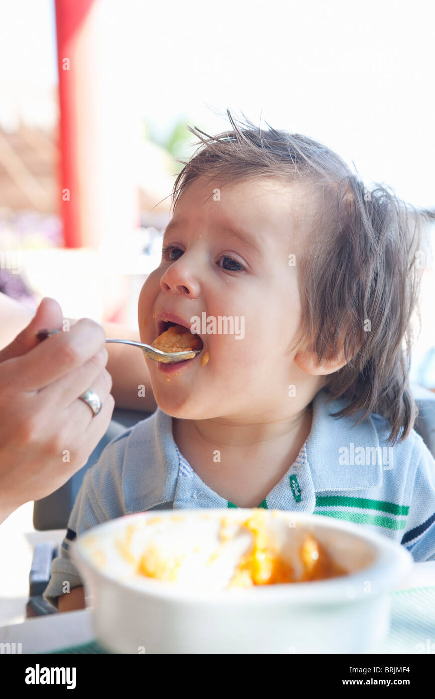 Mother Feeding Baby Boy Stock Photo - Alamy