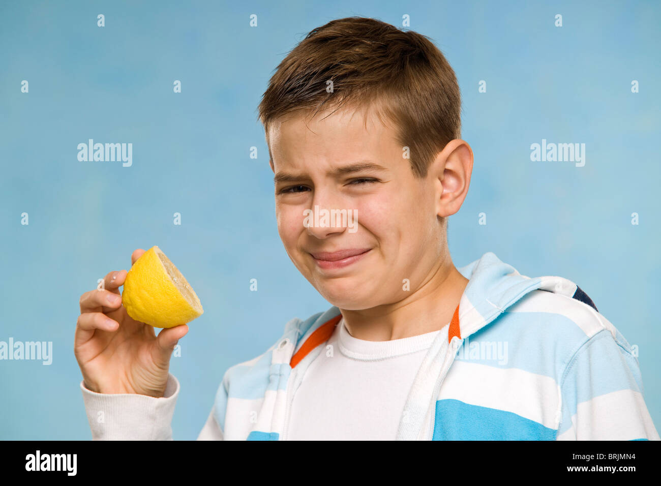 Boy Eating a Lemon Stock Photo - Alamy