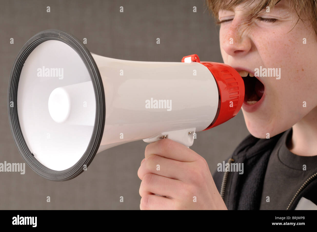 Kid shouting through megaphone hi-res stock photography and images - Alamy