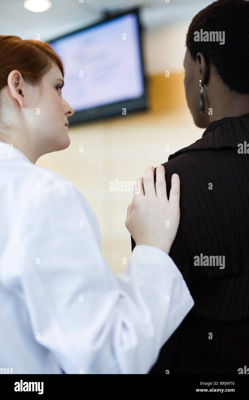 Female healthcare worker showing concern for patient Stock Photo - Alamy