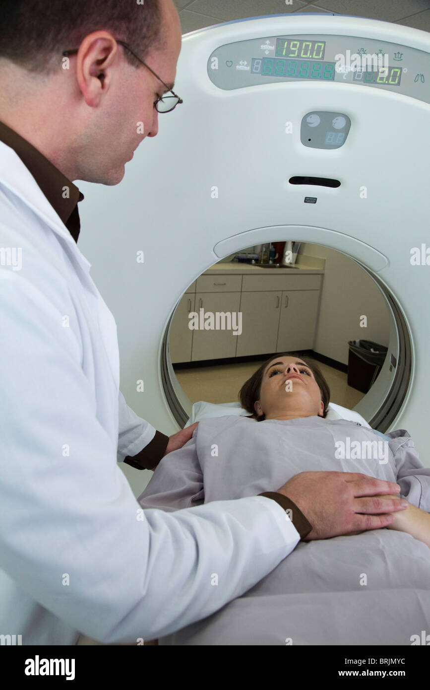 Doctor reassuring female patient preparing to undergo CAT scan Stock ...