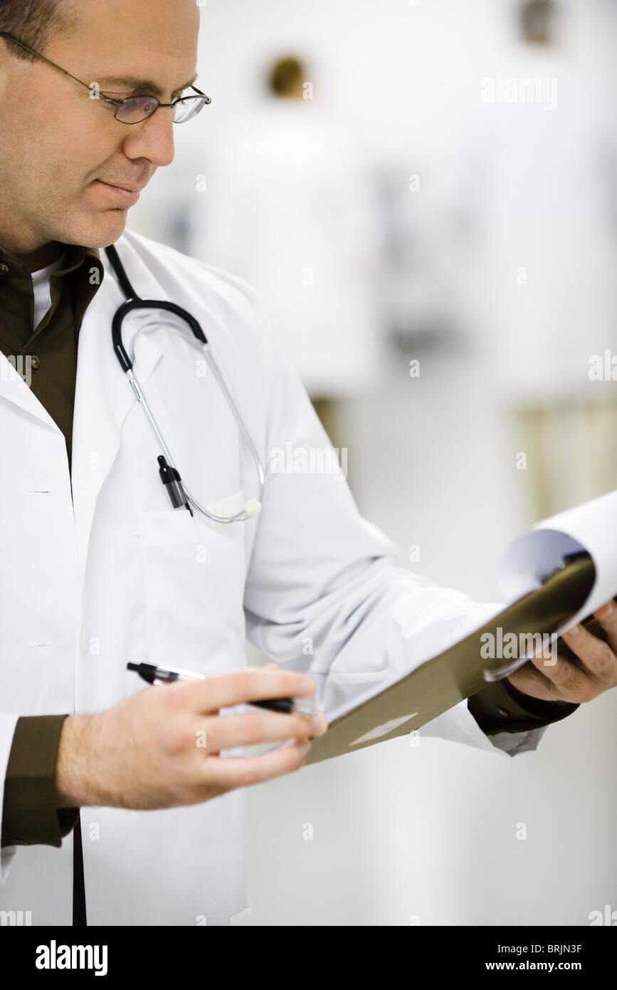 Doctor looking at medical chart Stock Photo - Alamy