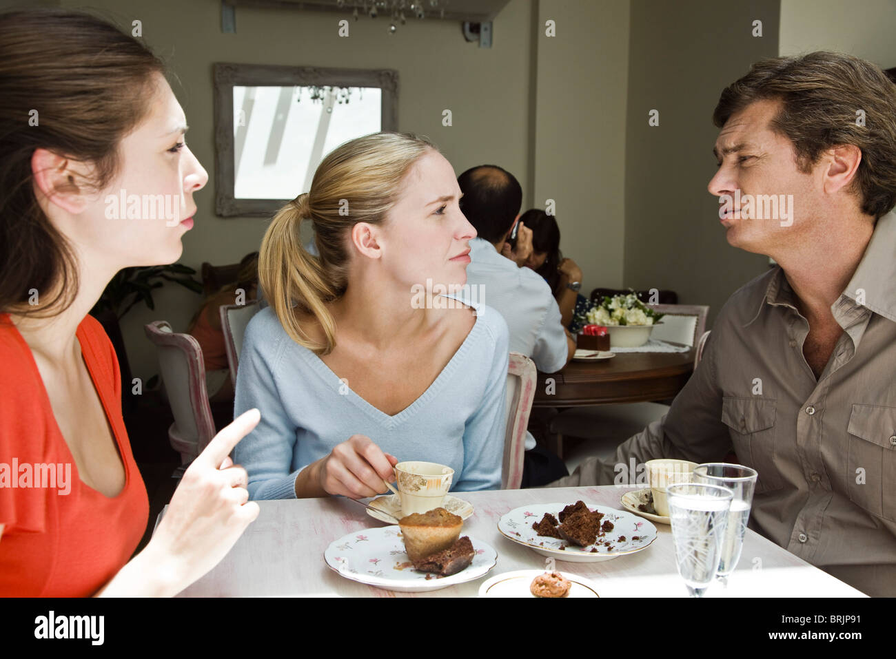 Friends having discussion at cafe Stock Photo - Alamy