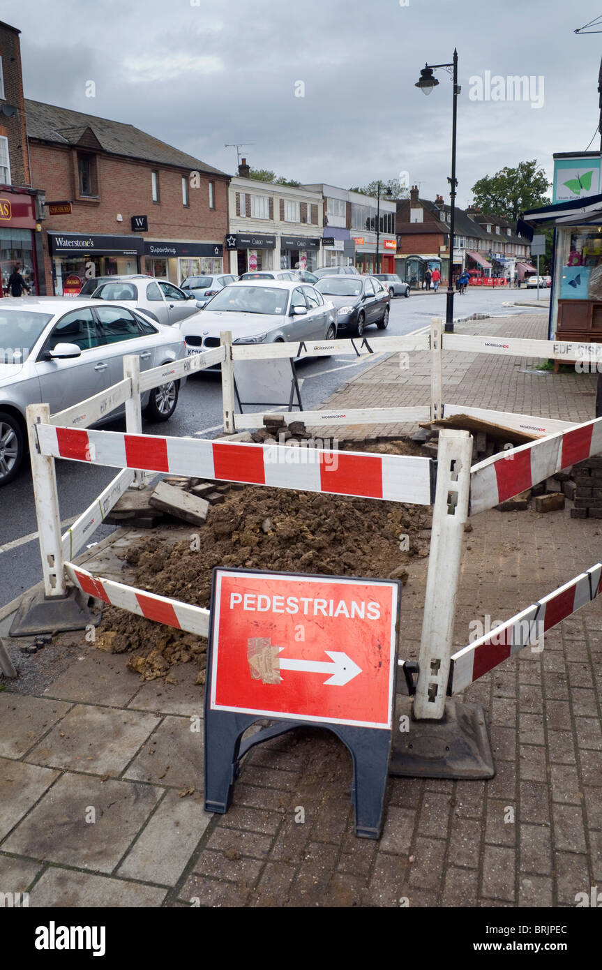 Road works public barriers and pedestrian diversion sign in a high ...
