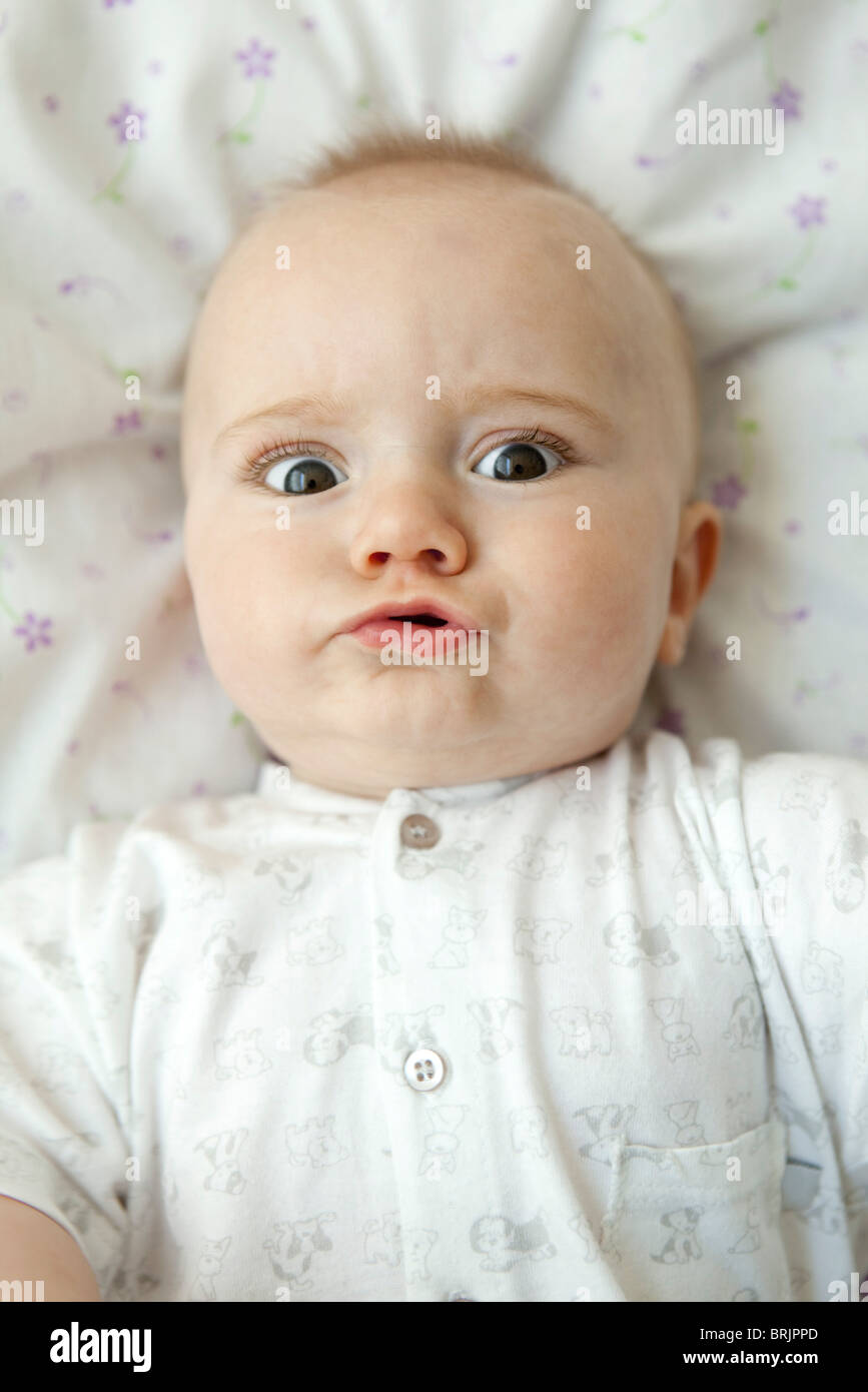 Baby making faces at camera, portrait Stock Photo - Alamy