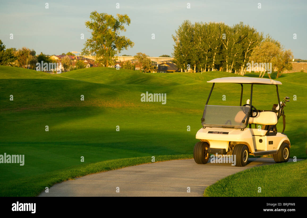 A golf cart on a curvy path of a golf course on a sunny day Stock Photo ...