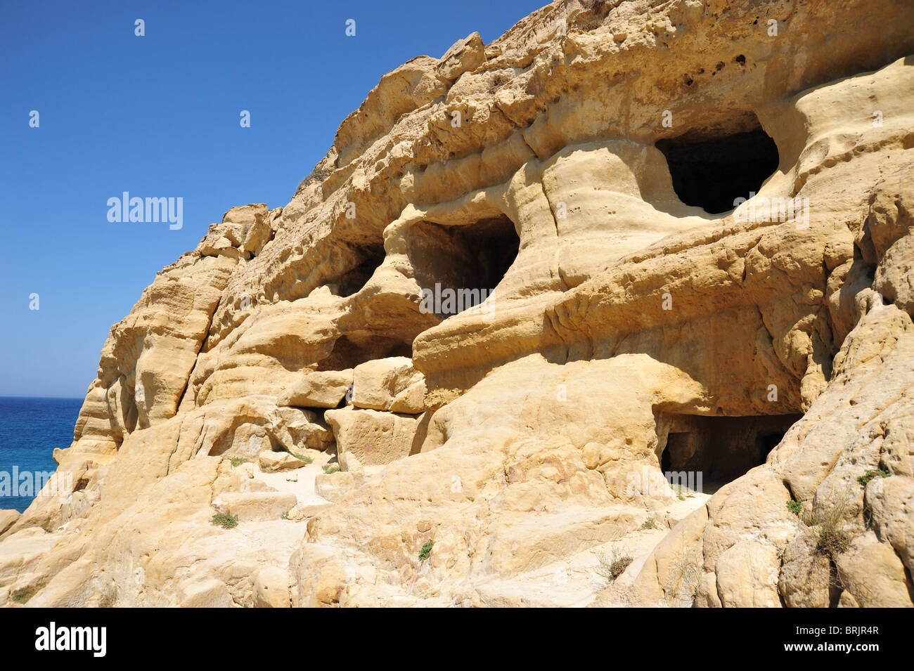 The sandstone cliffs at Matala in Southern Crete, Greece Stock Photo ...