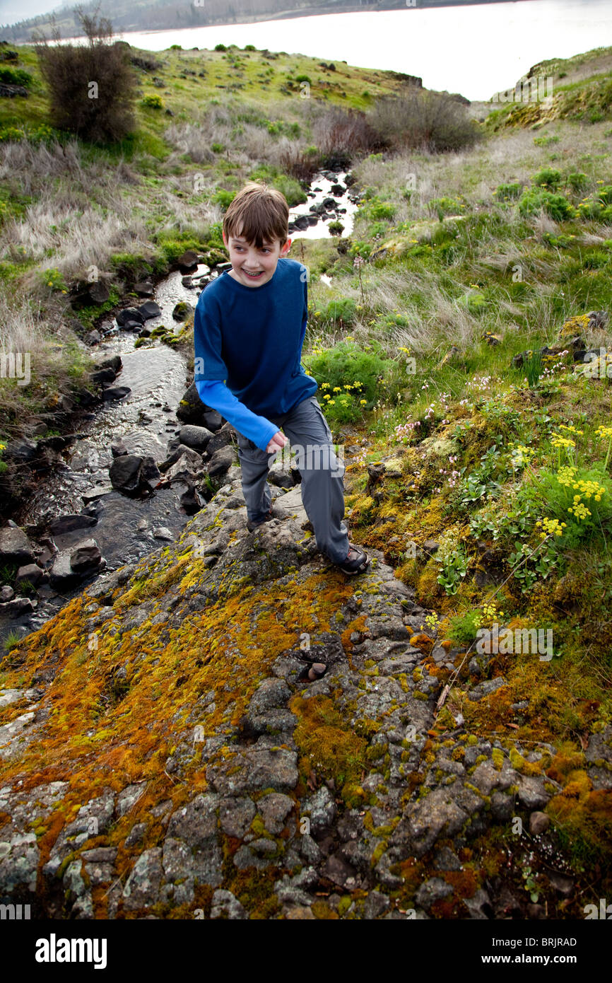 A young boy hiking along a stream Stock Photo - Alamy