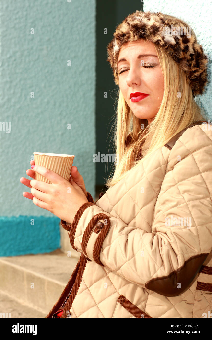 Young Woman Sitting Down Drinking Tea. Model Released Stock Photo - Alamy