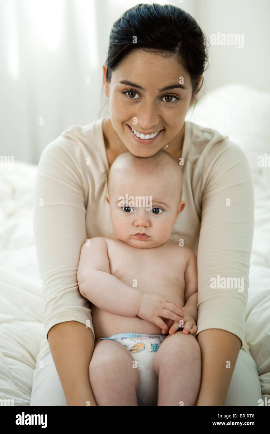 Mother holding baby on lap, portrait Stock Photo - Alamy