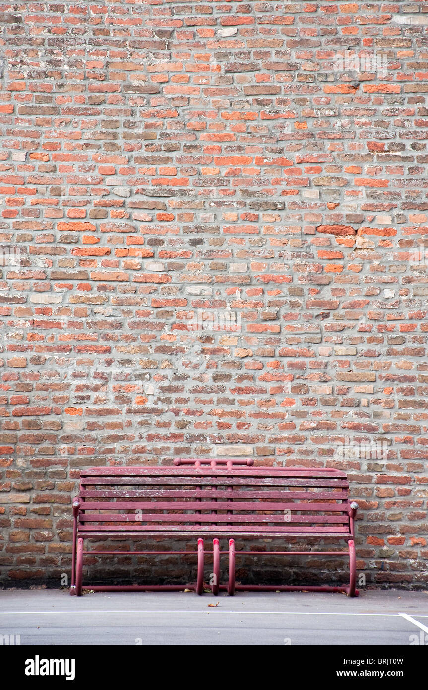 Bench against a brick wall; urban scenery Stock Photo - Alamy