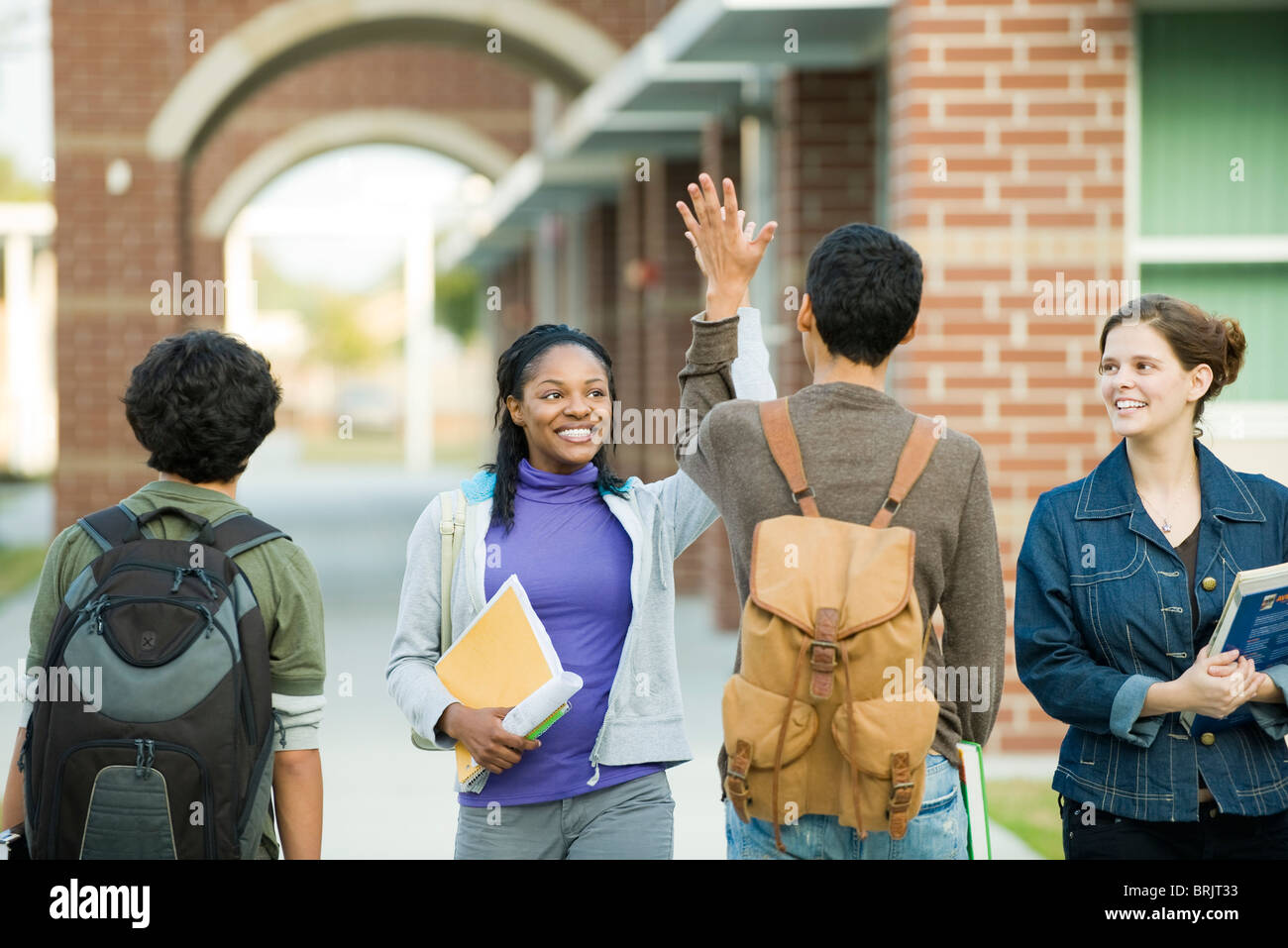 Classmates giving each other high-five Stock Photo - Alamy