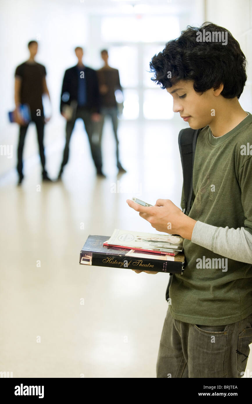 Teenage boy checking cell phone while on the move Stock Photo - Alamy
