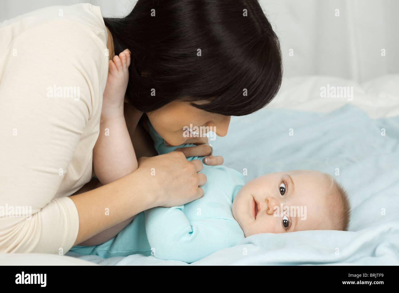 Mother cuddling baby Stock Photo - Alamy