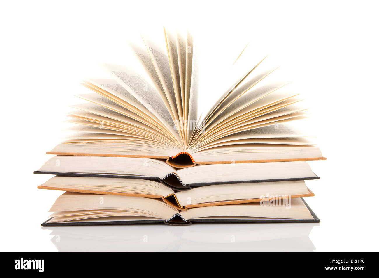 pile of open books isolated on white background Stock Photo - Alamy