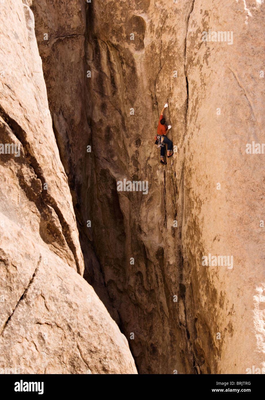 A young man climbing a long crack Stock Photo - Alamy