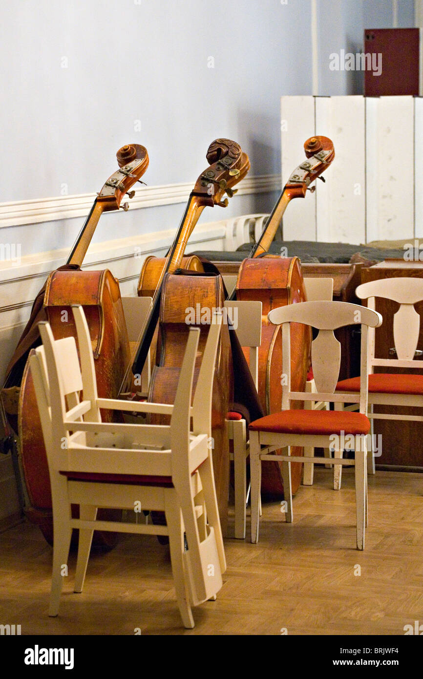 Four double basses leaning against chairs of the St Petersburg ...