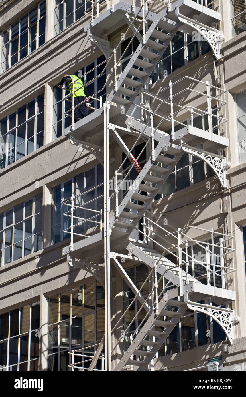 Painting fire escape, central Manchester, England, UK Stock Photo - Alamy