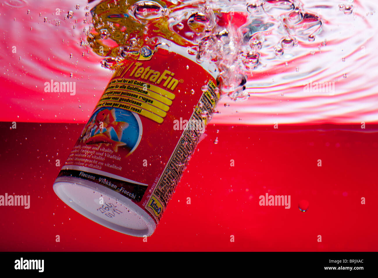 A can of fish food plunging into the water of a fishtank Stock Photo ...