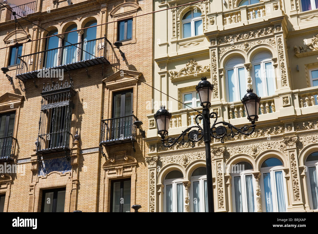 lamp and structural tram wire support in sevilla, spain Stock Photo - Alamy