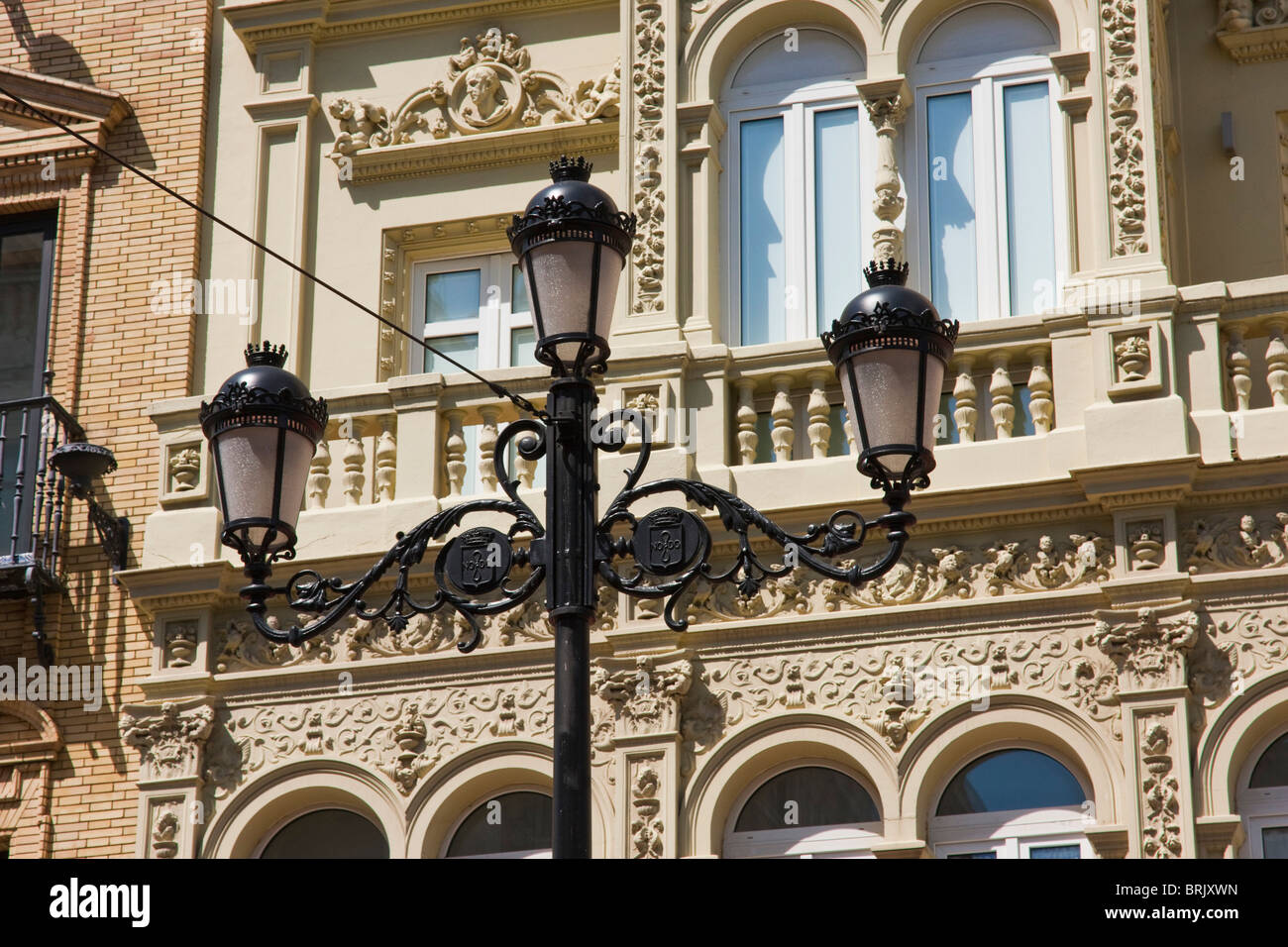lamp and structural tram wire support in sevilla, spain Stock Photo - Alamy