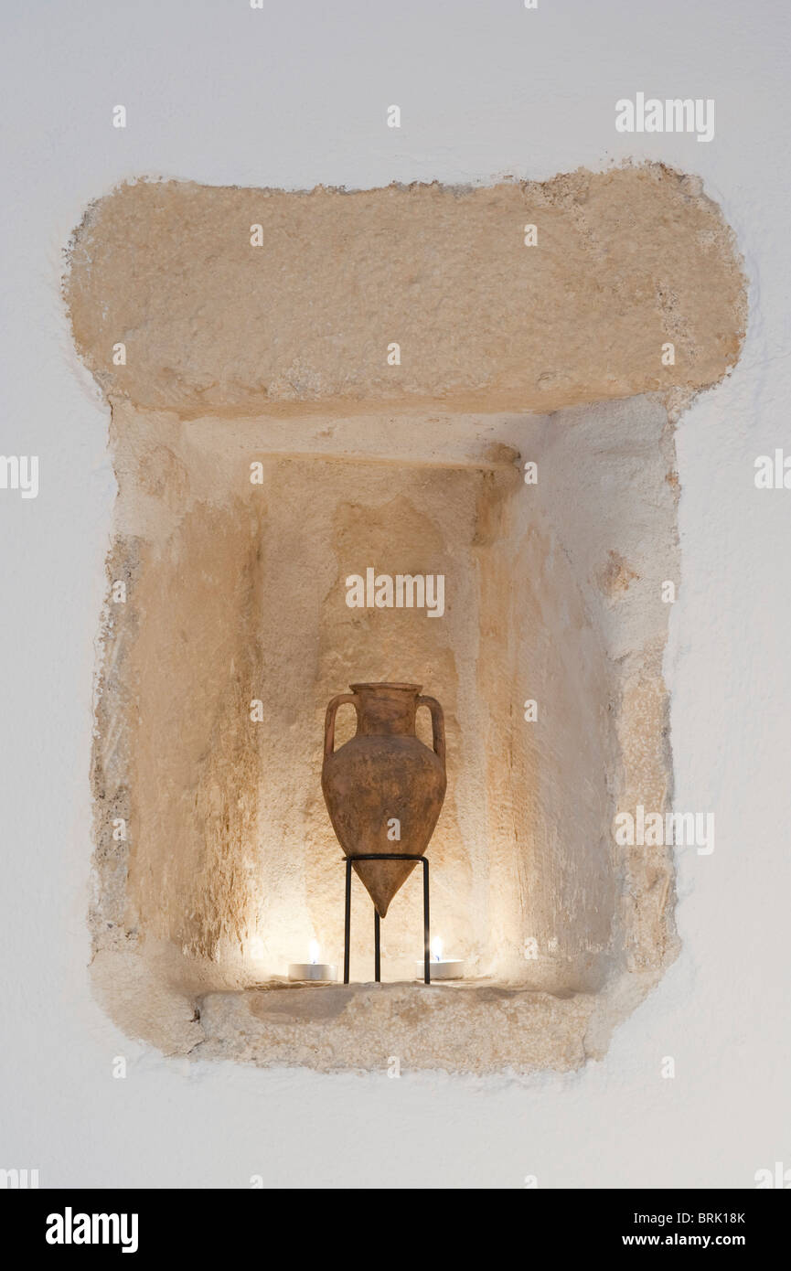 Limestone alcove with Greek urn miniature illuminated by candles Stock ...