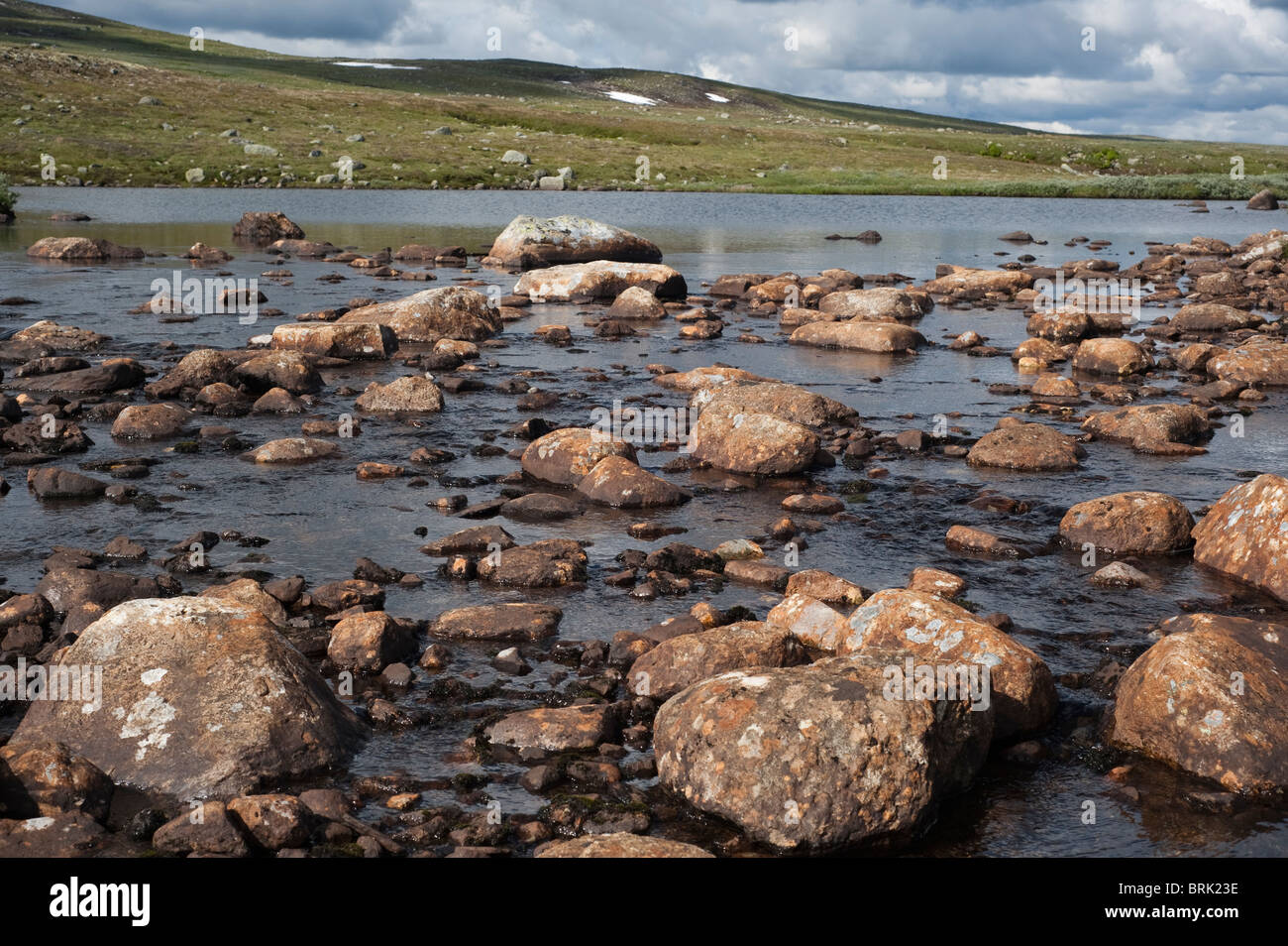 Rocks in lake on mountain plateau Stock Photo - Alamy