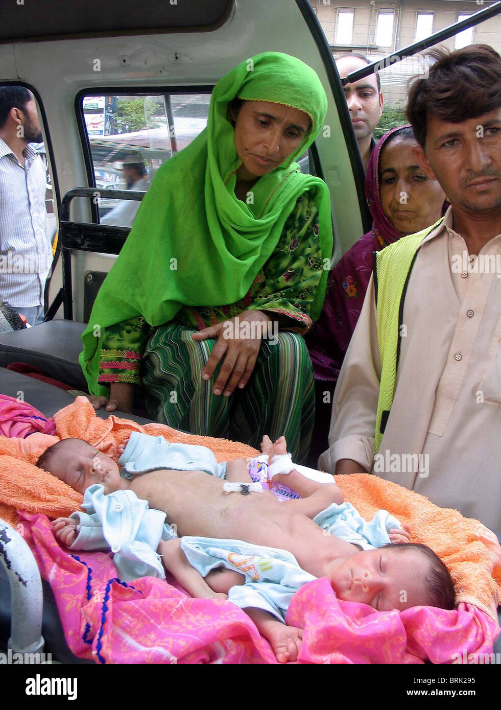 Karim Bibi a flood affectee from Thatta area sadly looks her conjoined ...