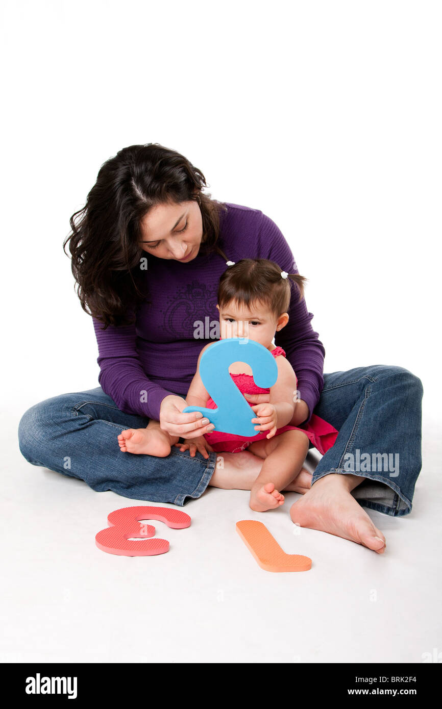 Mother, nanny, or teacher teaching baby to learn how to count one, two ...