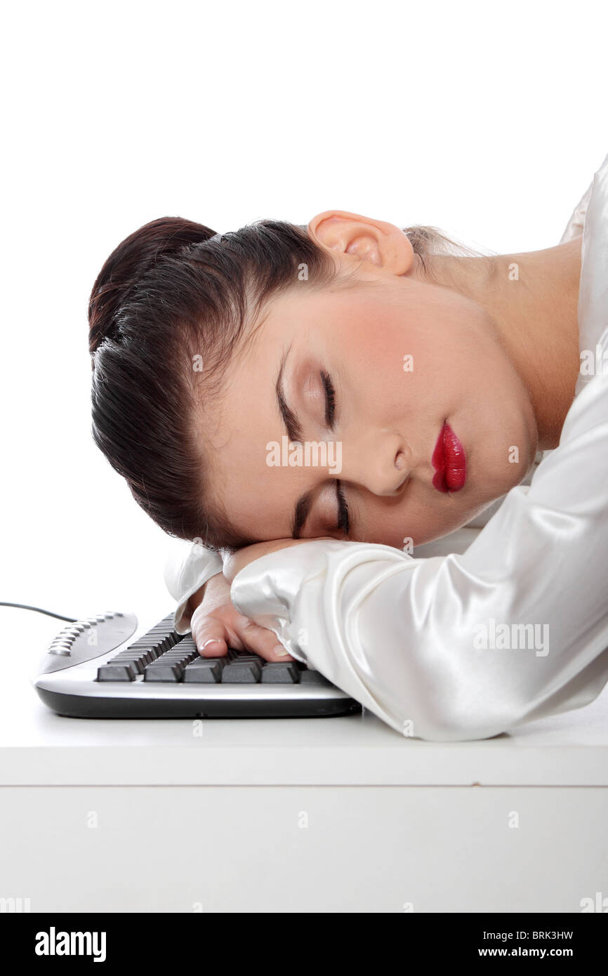 Young businesswoman sleeping on the keyboard in the office. Isolated on ...