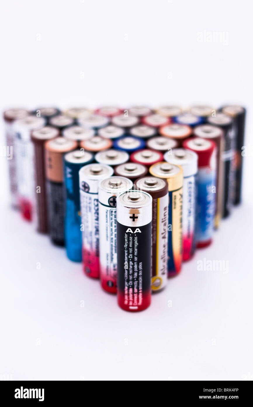 large triangular cluster of exhausted batteries on white background ...