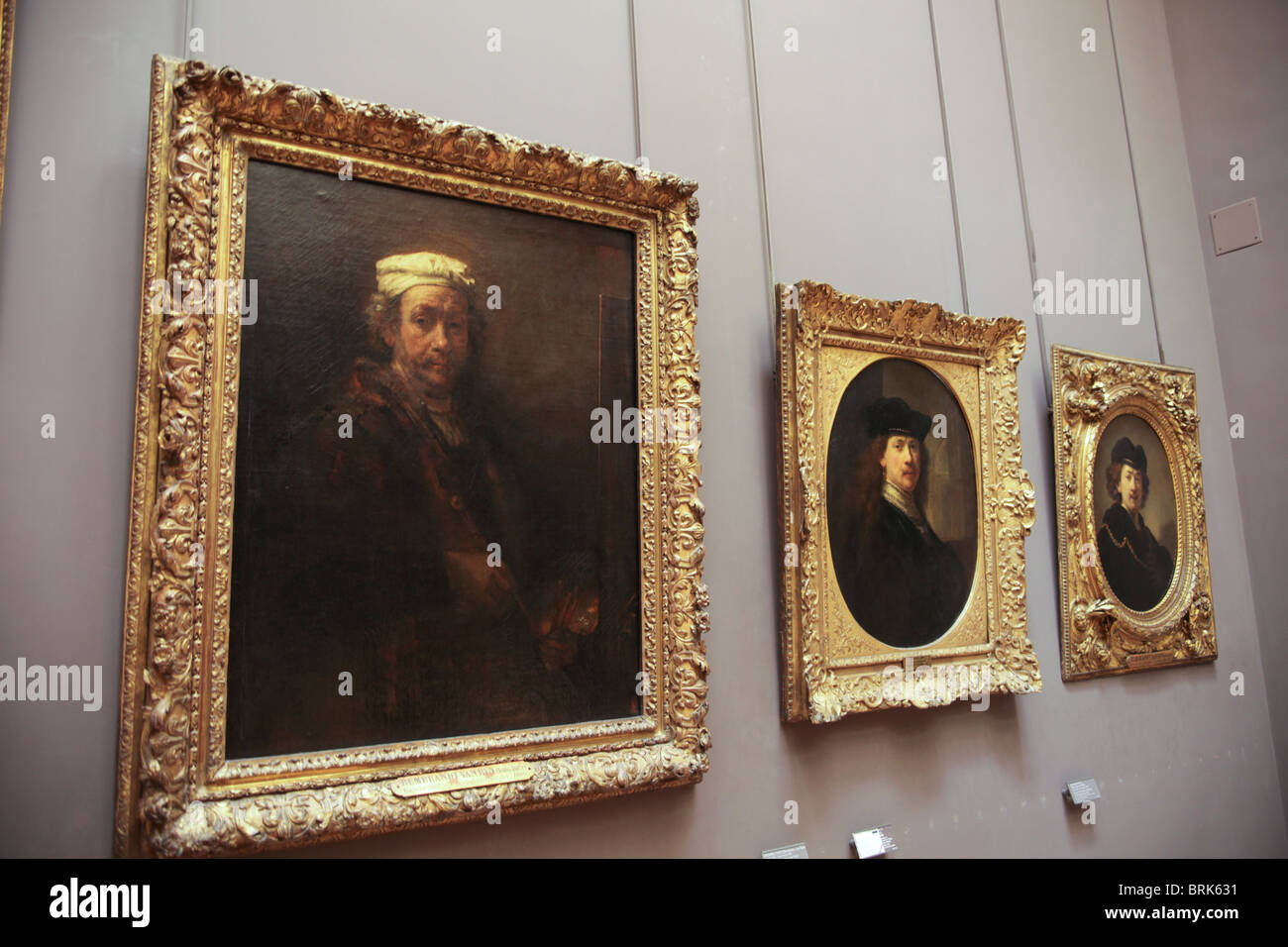 Three self portraits of Rembrandt on a wall in the Louvre museum in ...