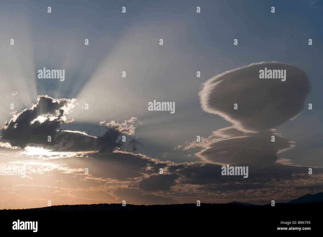 Crepuscular sun rays and lenticular cloud formations Stock Photo - Alamy