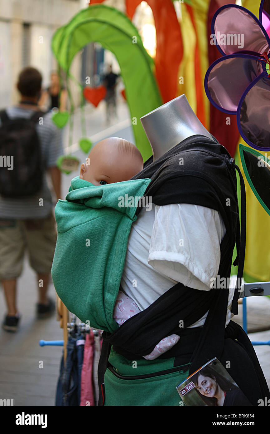 Headless mannequin and doll modelling baby carrier Stock Photo - Alamy