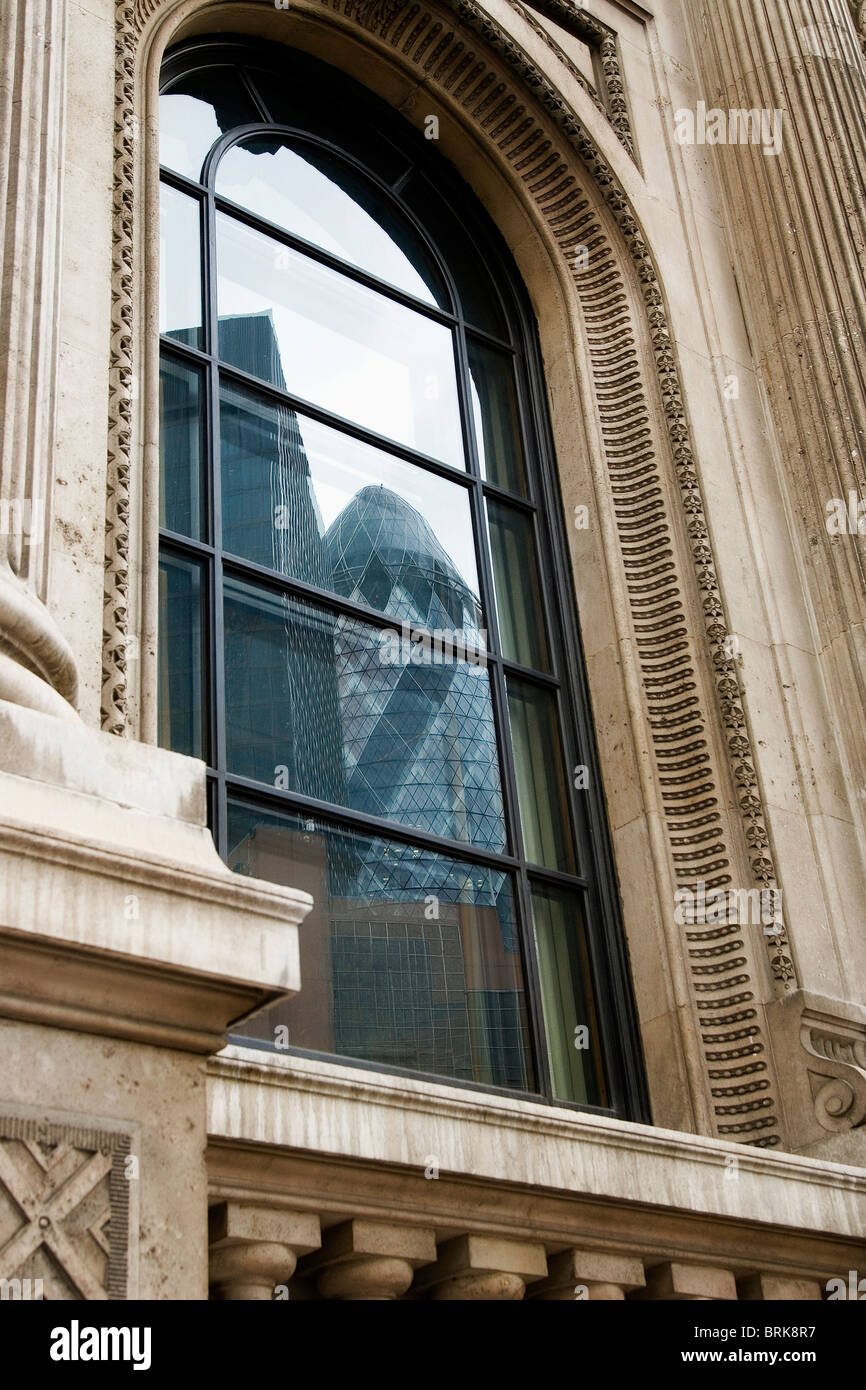 The Gherkin reflected in an older traditional window in the City of ...