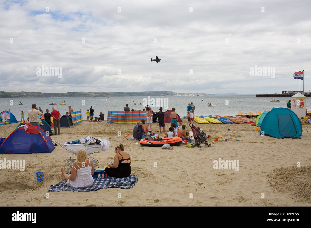 A WWII Lancaster bomber flies over the sea at Weymouth beach Stock ...