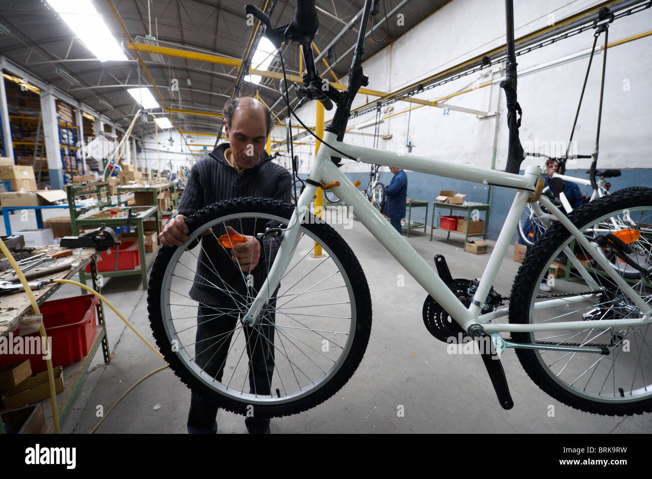 Worker at the assembly line of a bicycle factory Stock Photo - Alamy