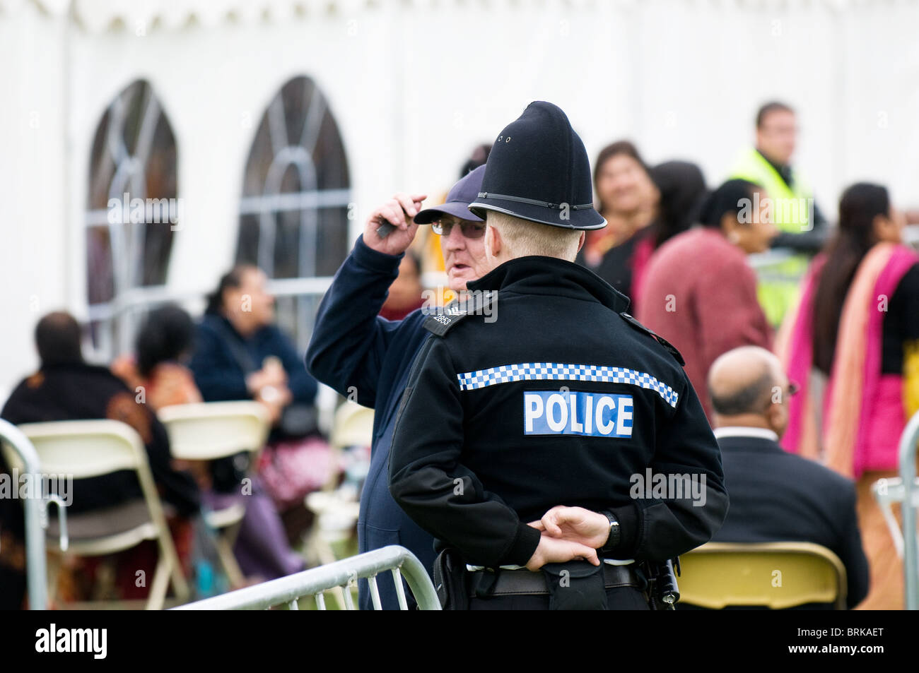 A police officer talking to a member of the public at the Ganesh ...