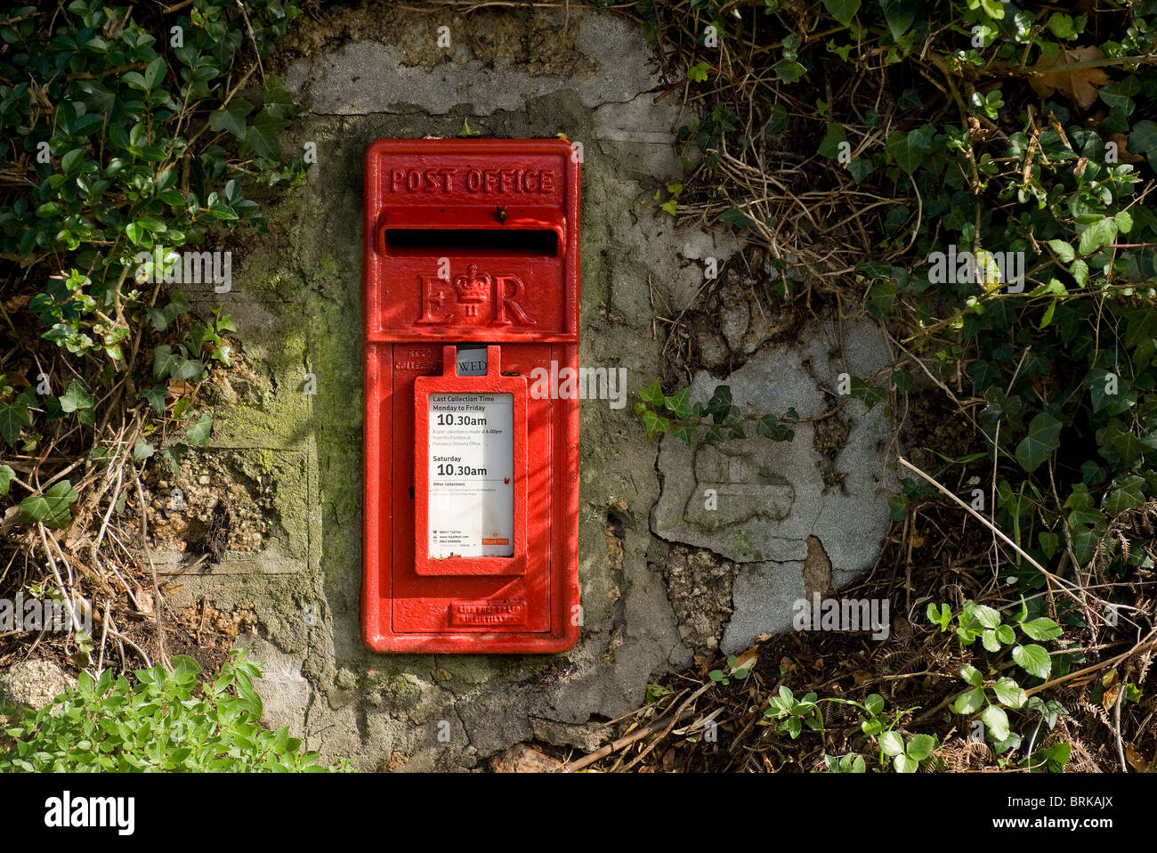 A traditional British red post box set into a wall Stock Photo - Alamy